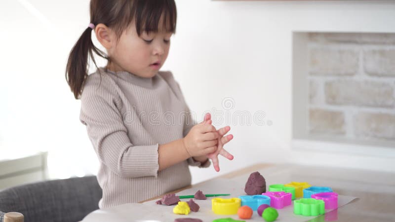 Girl playing with clay stock video. Video of bright - 325015209
