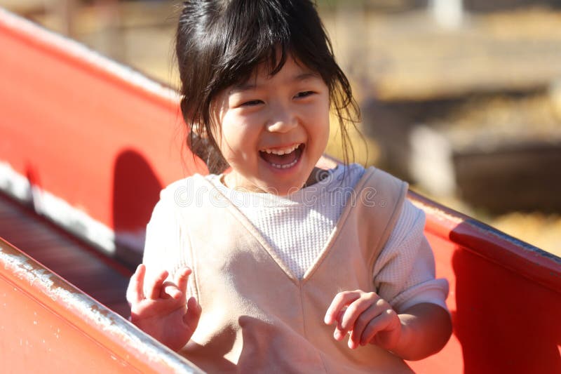 Girl playing on a slide stock image. Image of playing - 344483815