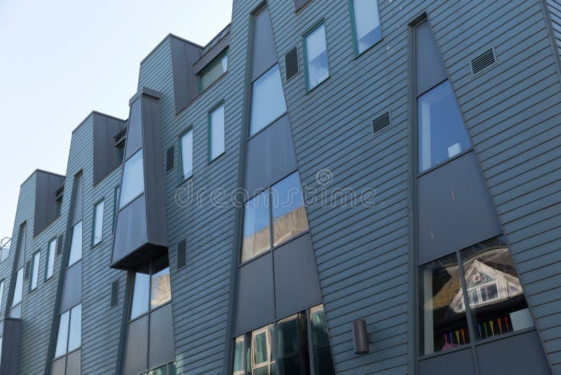An Image of a Grey Metal Cladded Facade with Angled Lines Dividing the ...