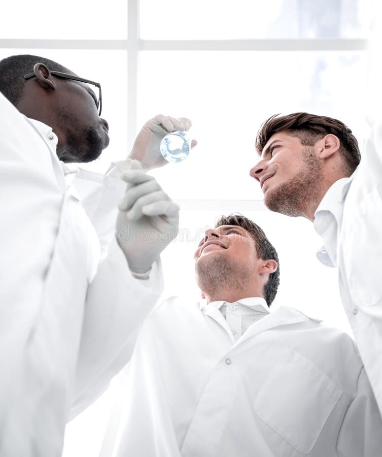 Group of Scientists Looking at the Results of Their Experiment. Stock ...