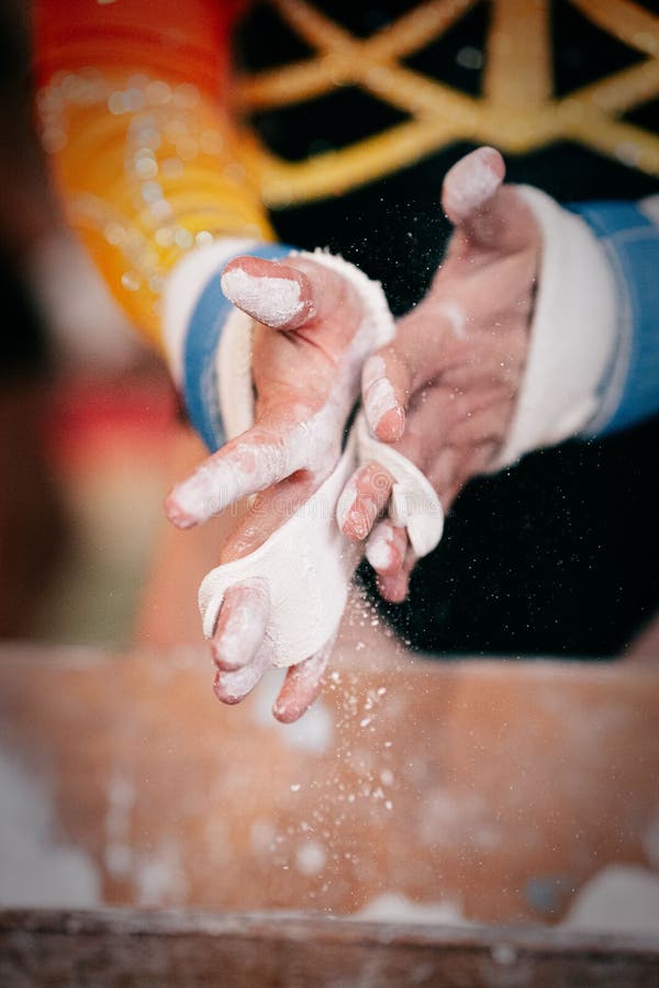 Image of a Gymnast Dusting Their Hands with Chalk before a Performance ...