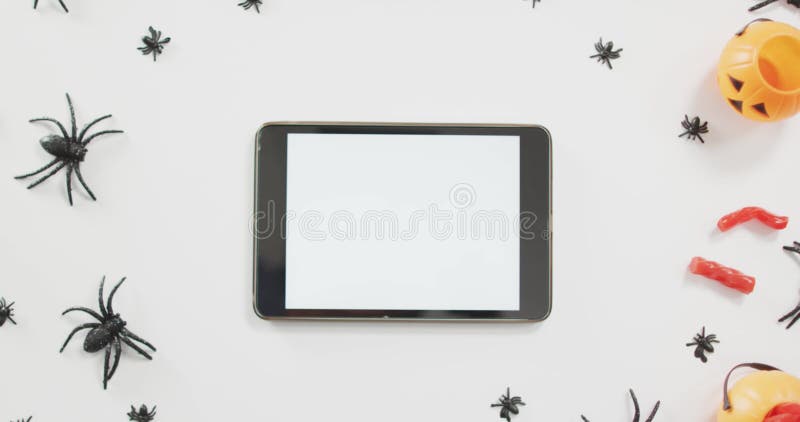 Image of Halloween Spiders, Bats and Decorations Over Tablet on White ...