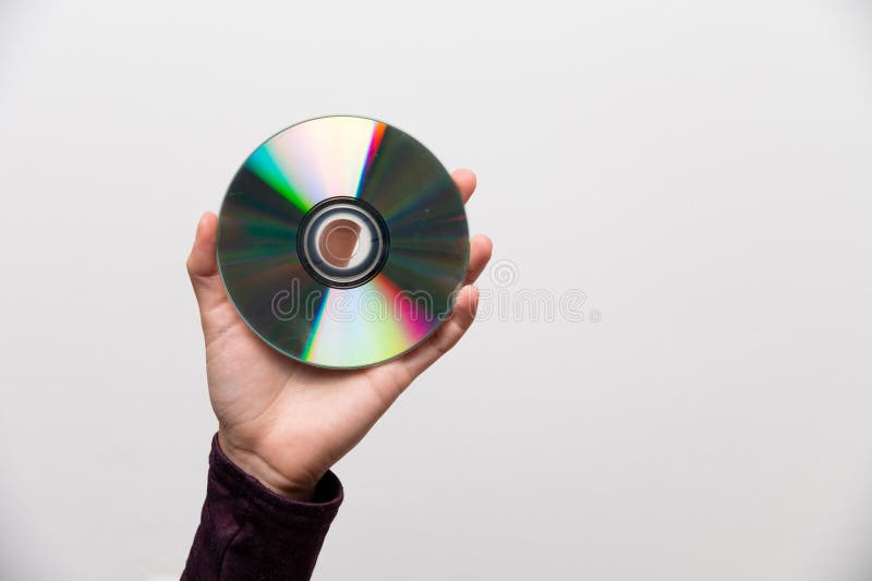 Image of a Hand Holding a CD, a Metaphor for Data Protection. CD in a ...