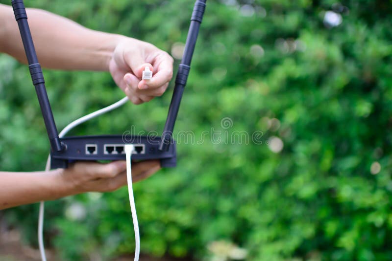 Image of a Hand of a Man with a White Cable Internet and Hold Modem ...
