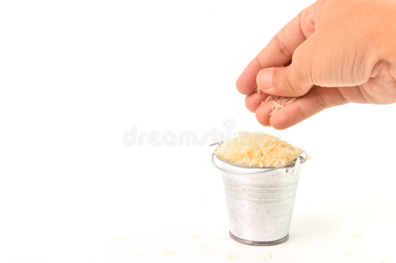 An Image of Hand Pouring Raw Rice in a Steel Cup Isolated on a White ...