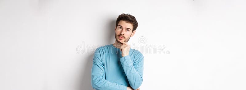 Image of Handsome Young Man Making Choice, Thinking and Looking Pensive ...