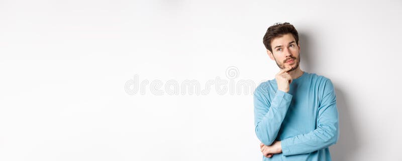 Image of Handsome Young Man Making Choice, Thinking and Looking Pensive ...