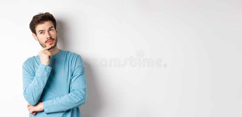 Image of Handsome Young Man Making Choice, Thinking and Looking Pensive ...