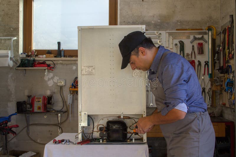 Plumber Repairing Refrigerator Stock Photos - Free & Royalty-Free Stock ...