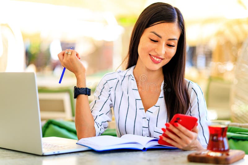 Image of Happy Asian Woman Using Laptop while Sitting at Cafe Stock ...