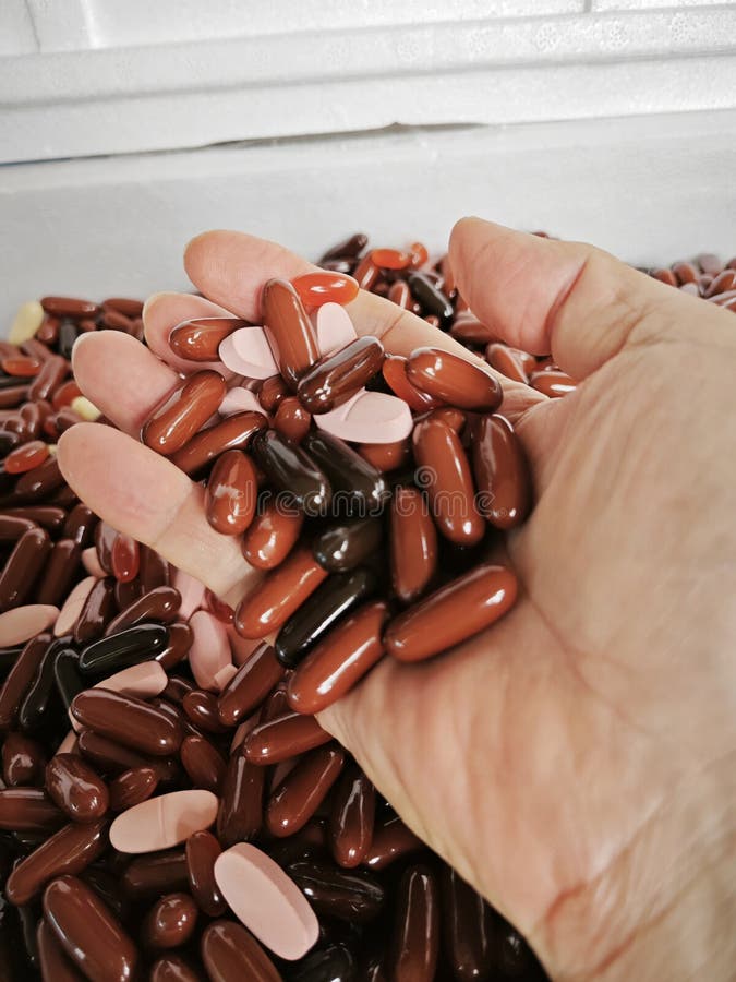 Holding a Stack of Capsule and Tablet Pills in the Hand. Stock Image ...