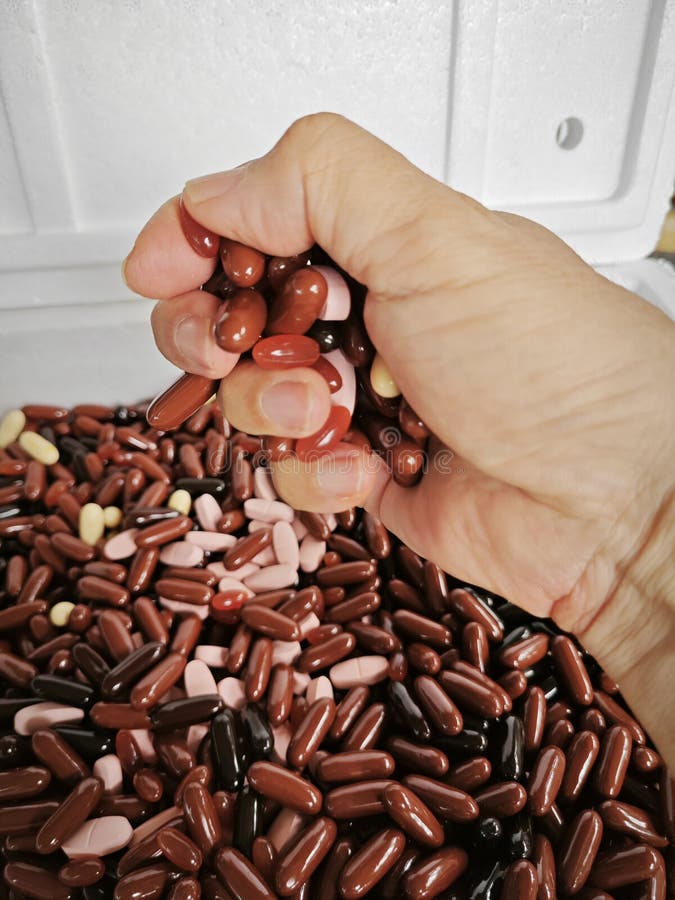Holding a Stack of Capsule and Tablet Pills in the Hand. Stock Photo ...