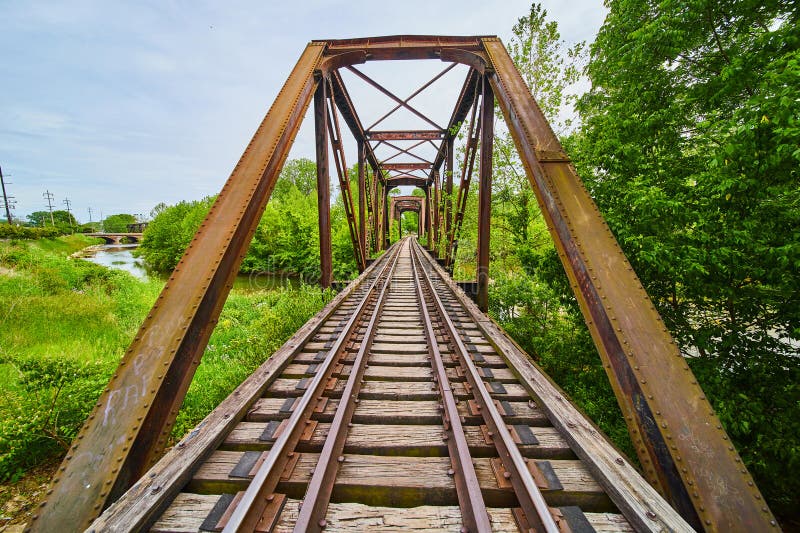 Horizontal Rusty Iron Railroad Bridge with Train Tracks Leading into ...