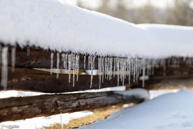 Icicles on a Snow-covered Fence during a Snowy Winter. Stock Image ...