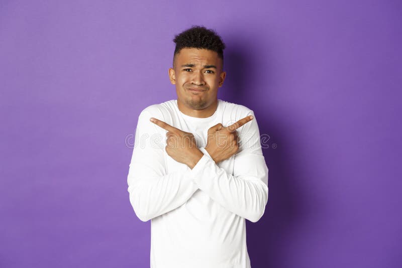 Image of Indecisive African American Woman Points Sideways and Smiles ...