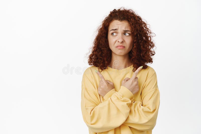 Image of Indecisive African American Woman Points Sideways and Smiles ...