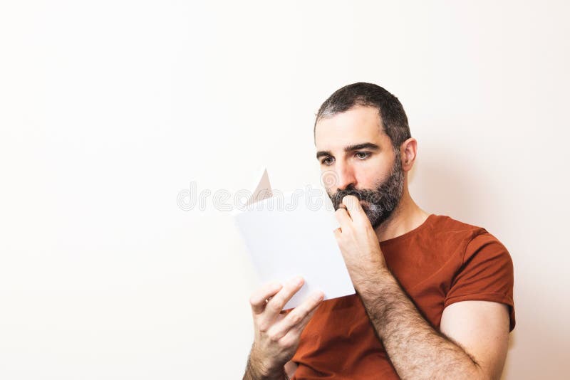 Image of an Isolated Young White Man with Beard, Focused Reading a Book ...