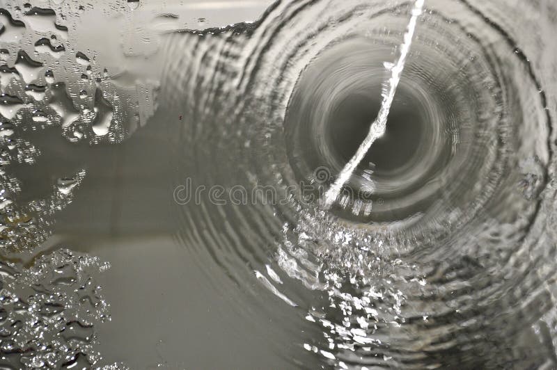 The Image with Jet of Falling Water. Drops of Water on a Dark Glass ...