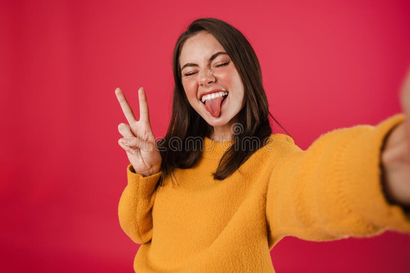 Image Of Joyful Girl Gesturing Peace Sign While Taking Selfie Photo