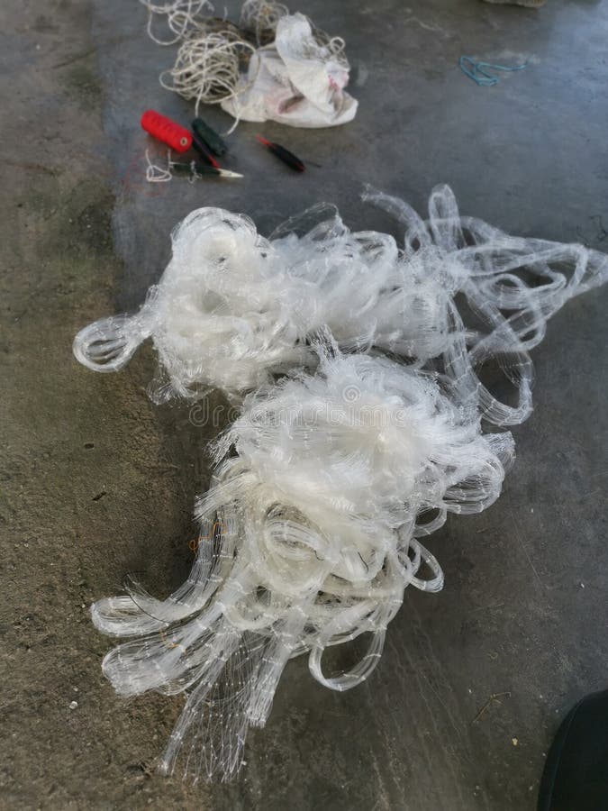 Knitting Fishing Net and Tool on the Ground. Stock Photo - Image of ...