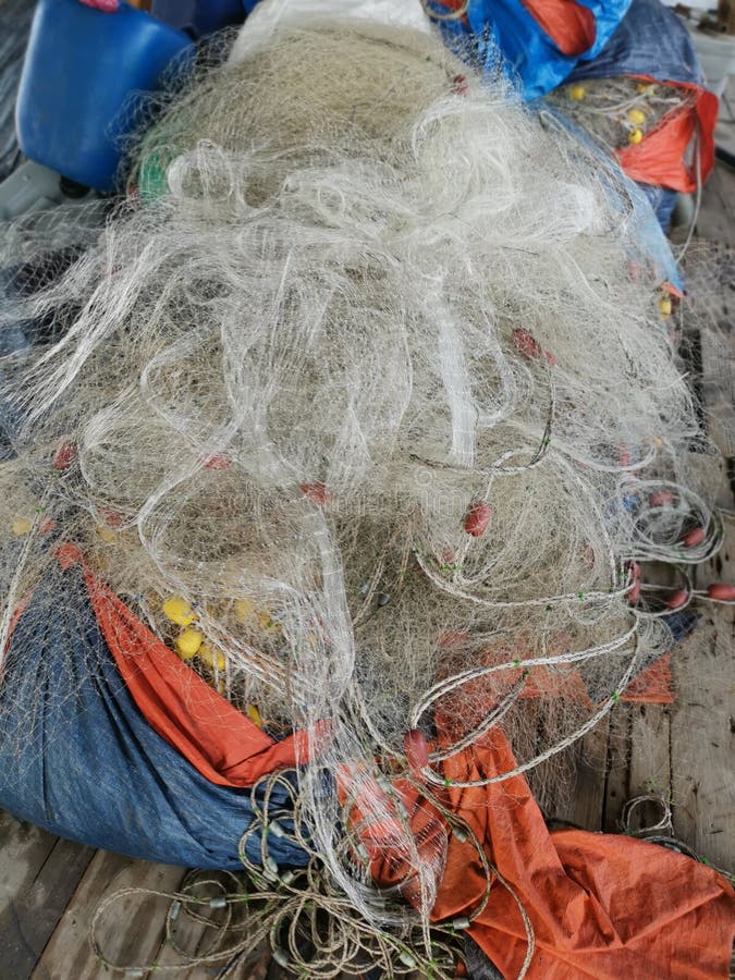 Knitting Fishing Net and Tool on the Ground. Stock Photo - Image of ...