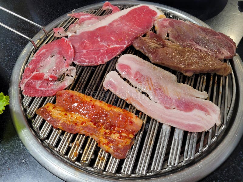 Image of a Korean Grill, Grilling Various Cuts of Meat Stock Photo ...