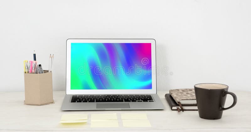 Image of Laptop with Colorful Moving Shapes on Screen on Desk Stock ...