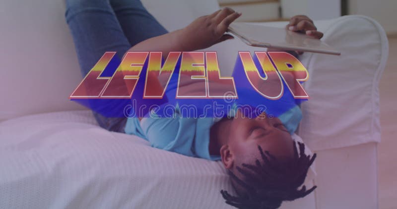 Image of Level Up Text Over African American Boy Using Tablet Stock ...