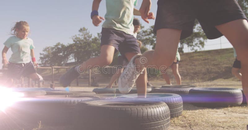 Image of Light Spots Over Diverse Schoolchildren Exercising on Obstacle ...
