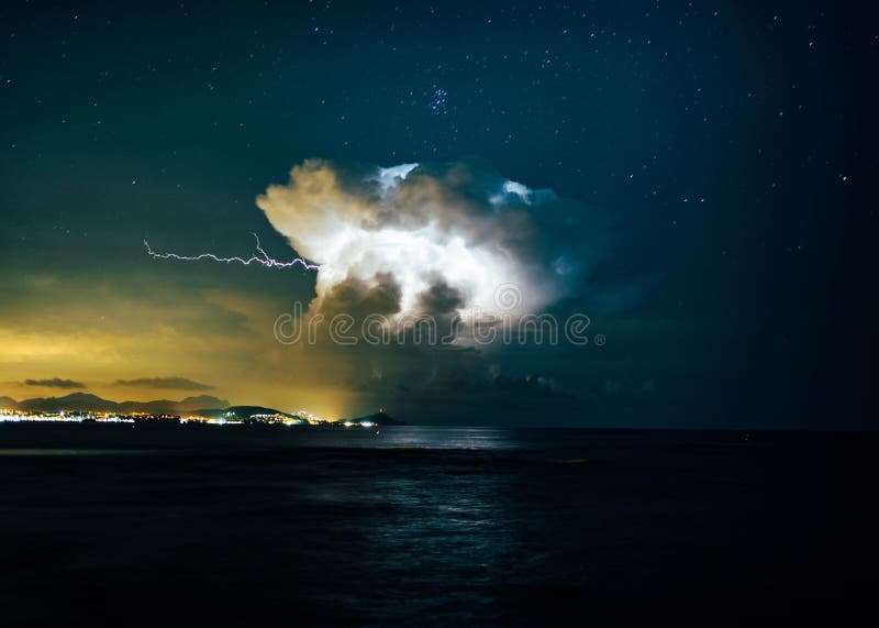An Image of Lightning and the Ocean at Night Time with Stars Stock ...
