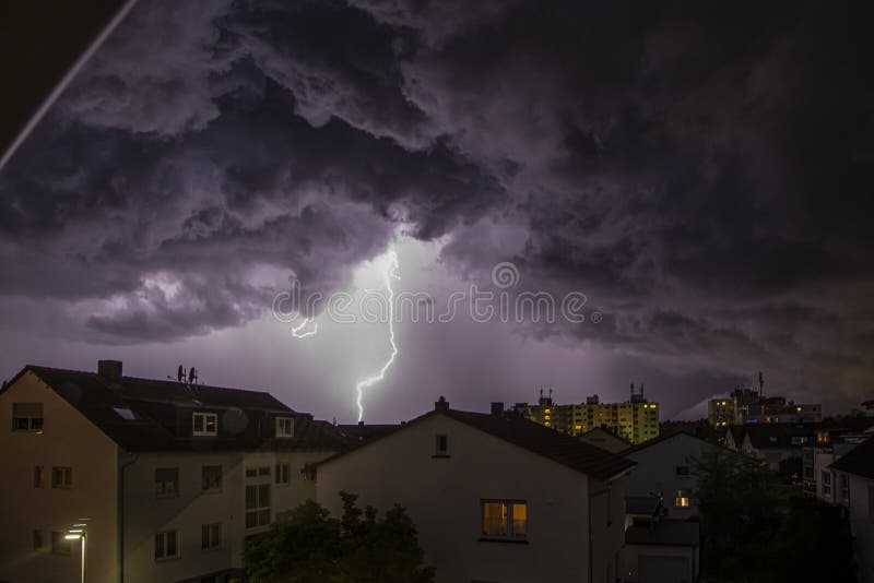 Image of Lightning Strike Over Buildings with Threatening Cloud ...