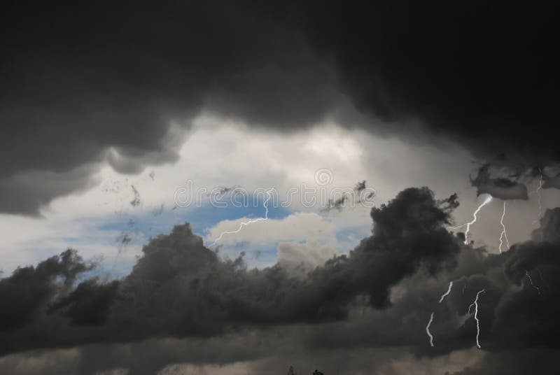 Lightning Strikes from Gathering Storm Clouds Against Sa Blue Sky Stock ...