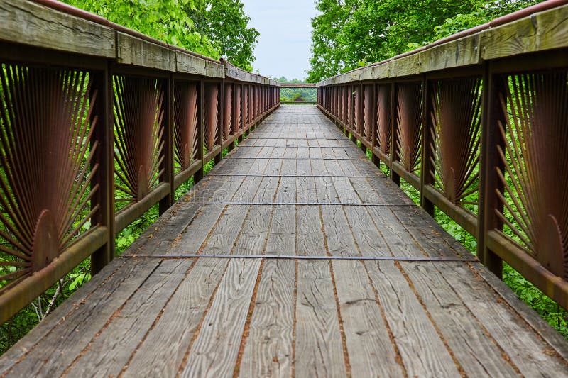 Low Angle of Bridge with Setting Sun Pattern on Railing and Wooden ...