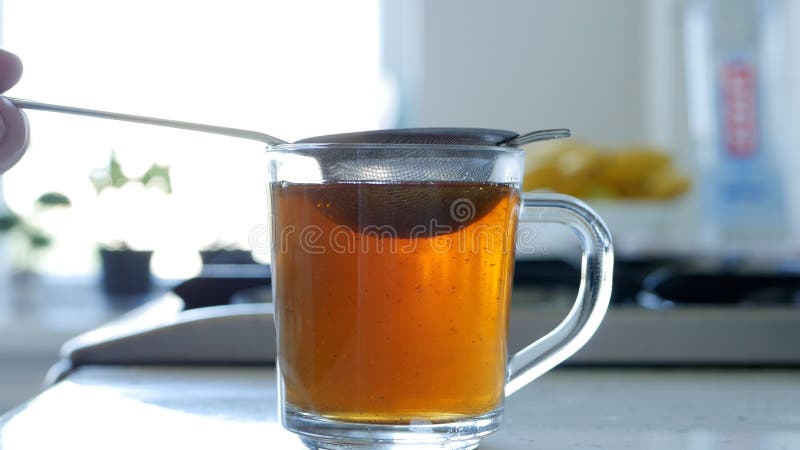Image with Making a Hot and Aromatic Tea Using a Strainer and Natural ...