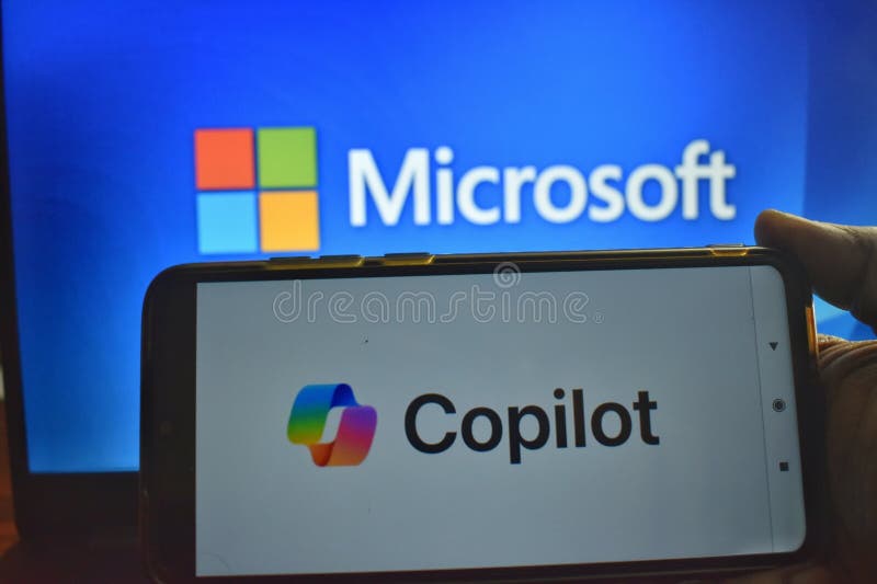 An Image of a Man Holding the Mobile Phone with Copilot on Screen ...
