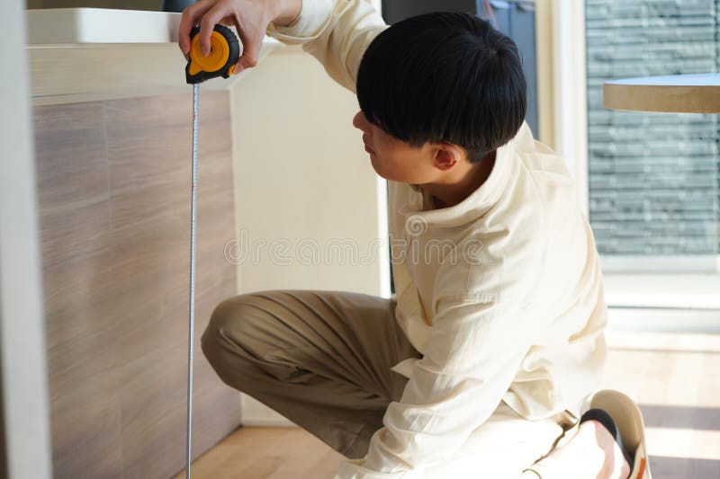 A Man Measuring the Height of a Room Stock Image - Image of measure ...
