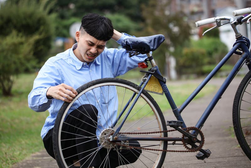 A Man with a Broken Bicycle Stock Image - Image of worried, young ...