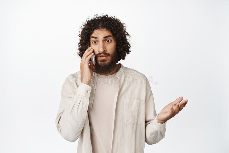 Image of Middle Eastern Man Talking on Mobile Phone, Looking Confused ...