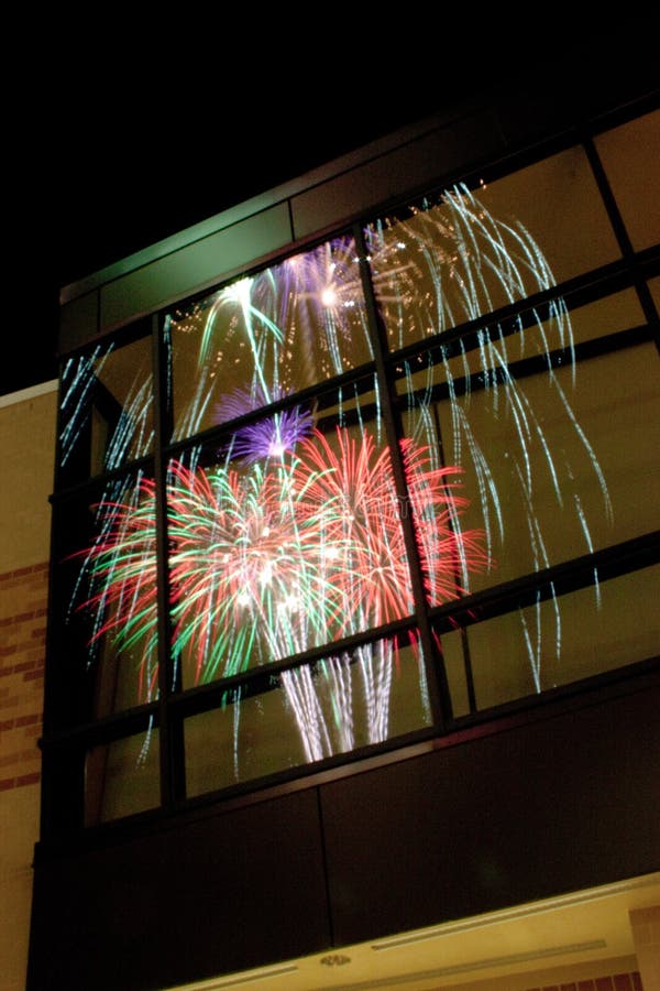 Multicolored Fireworks at Night through a Black Framed Window Stock ...