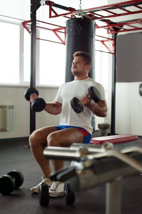 Image of Muscular Man Exercising in Gym Stock Photo - Image of building ...