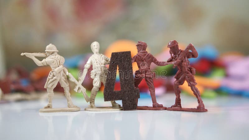 Image of Number 4 with Four Toy Soldiers at Background Stock Photo ...