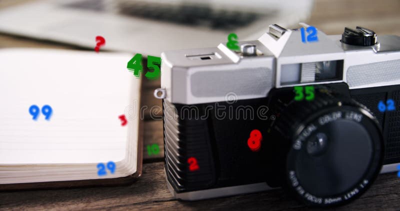 Image of Numbers Changing Over Close Up of Desk with Camera and Laptop ...