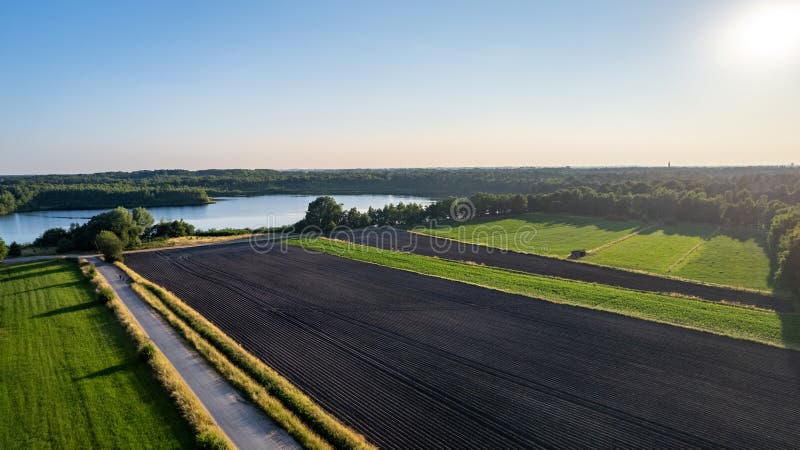 Aerial Perspective of Cultivated Fields by a Lake at Sunset Stock Photo ...