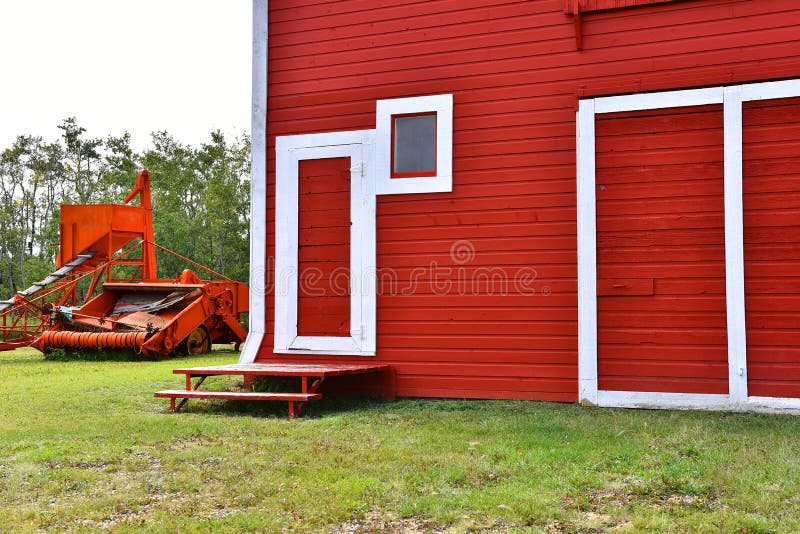 Antique Combine and Red Barn Stock Image - Image of wall, window: 127489717