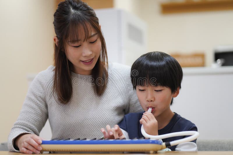 Parents and Children Practicing the Keyboard Harmonica Stock Image ...