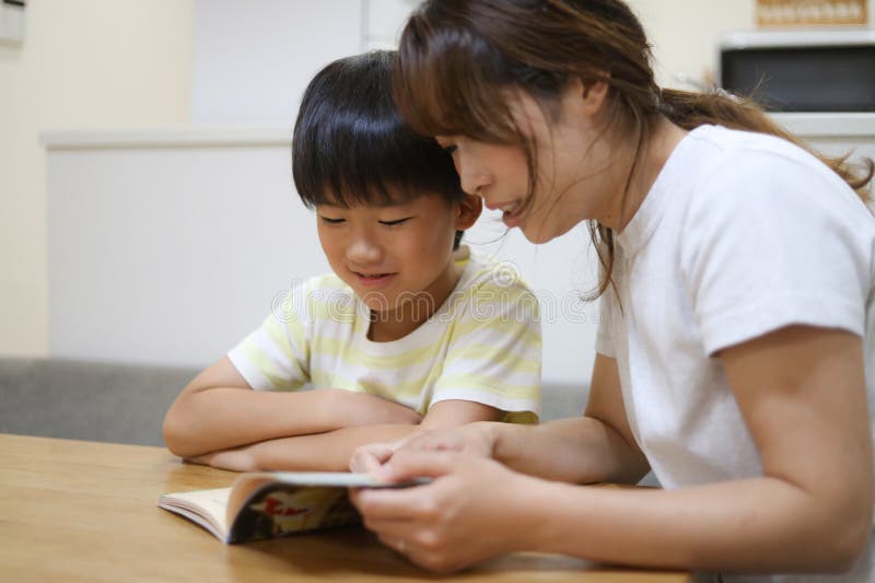 Parents and Children Reading a Book Stock Photo - Image of residence ...