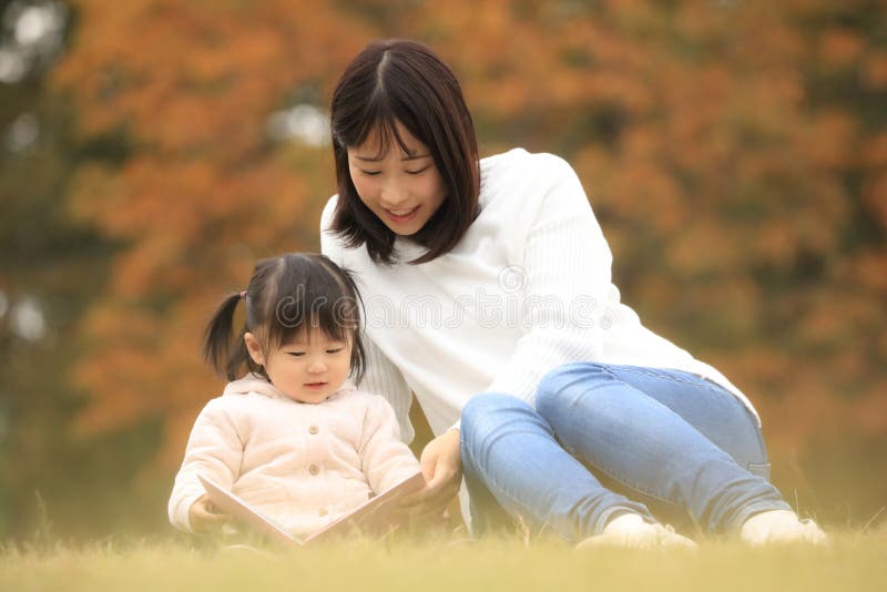 Parents and Children Reading Stock Photo - Image of outdoors, people ...