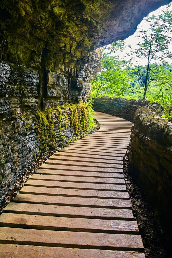 Peaceful Wood Boardwalk and Stone Wall Against Stone Cliffs with Moss ...