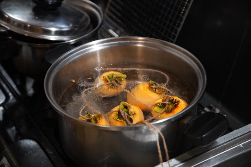 Dipping Persimmons in Boiling Water Stock Image - Image of lifestyle ...