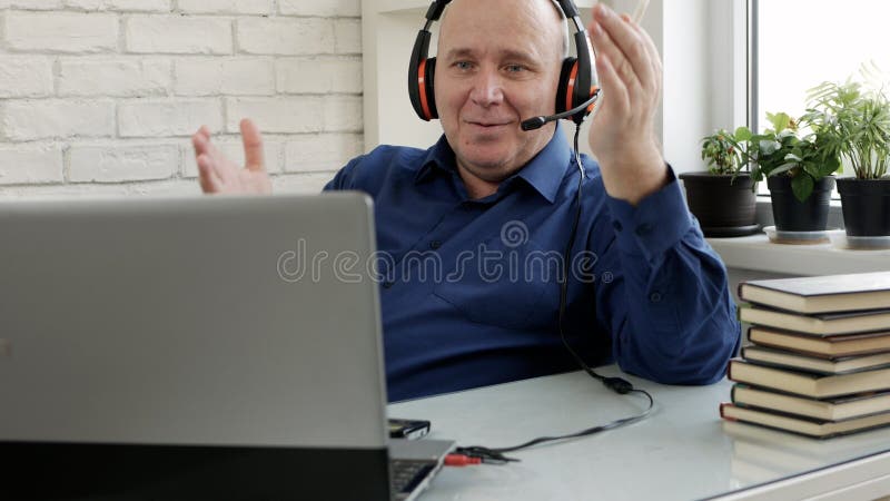 Image with a Person Using a Laptop and Headphones for an Online Video ...